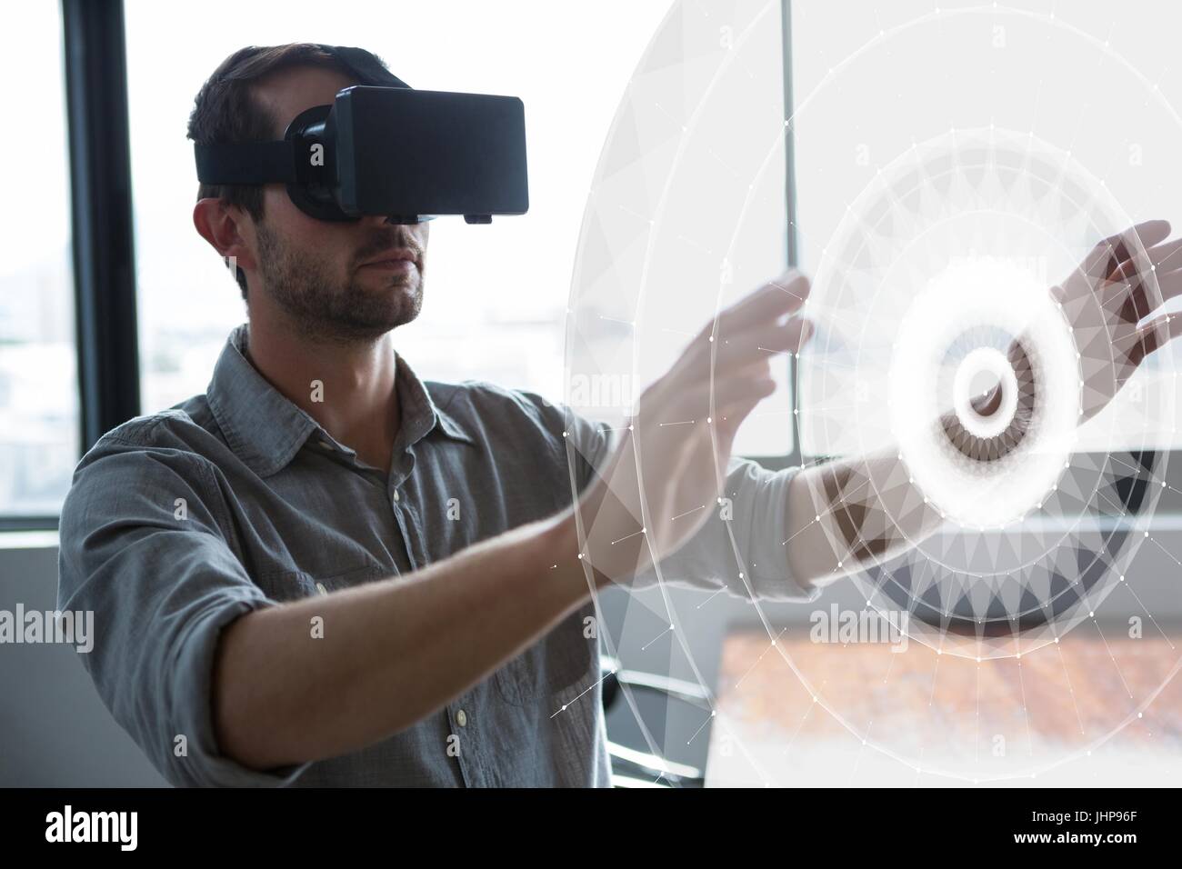 Digital composite of Man in VR headset touching interface Stock Photo ...