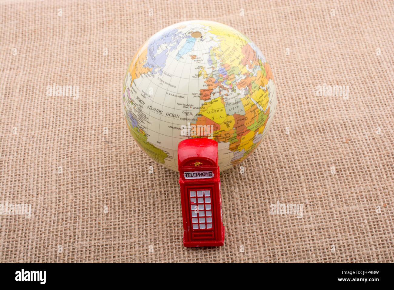 Globe with a telephone booth on canvas background Stock Photo - Alamy
