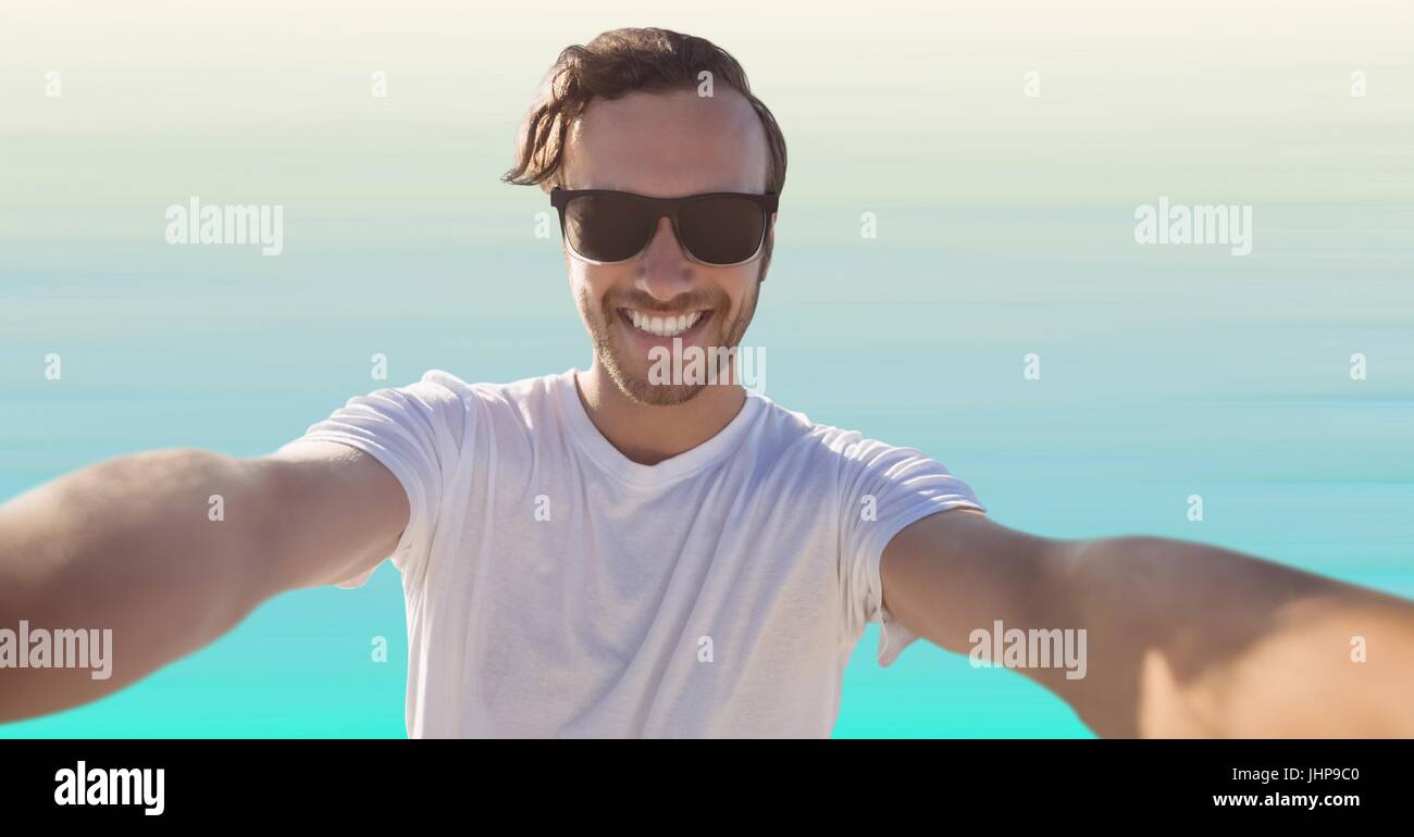 Digital composite of Man taking selfie against light blue background ...