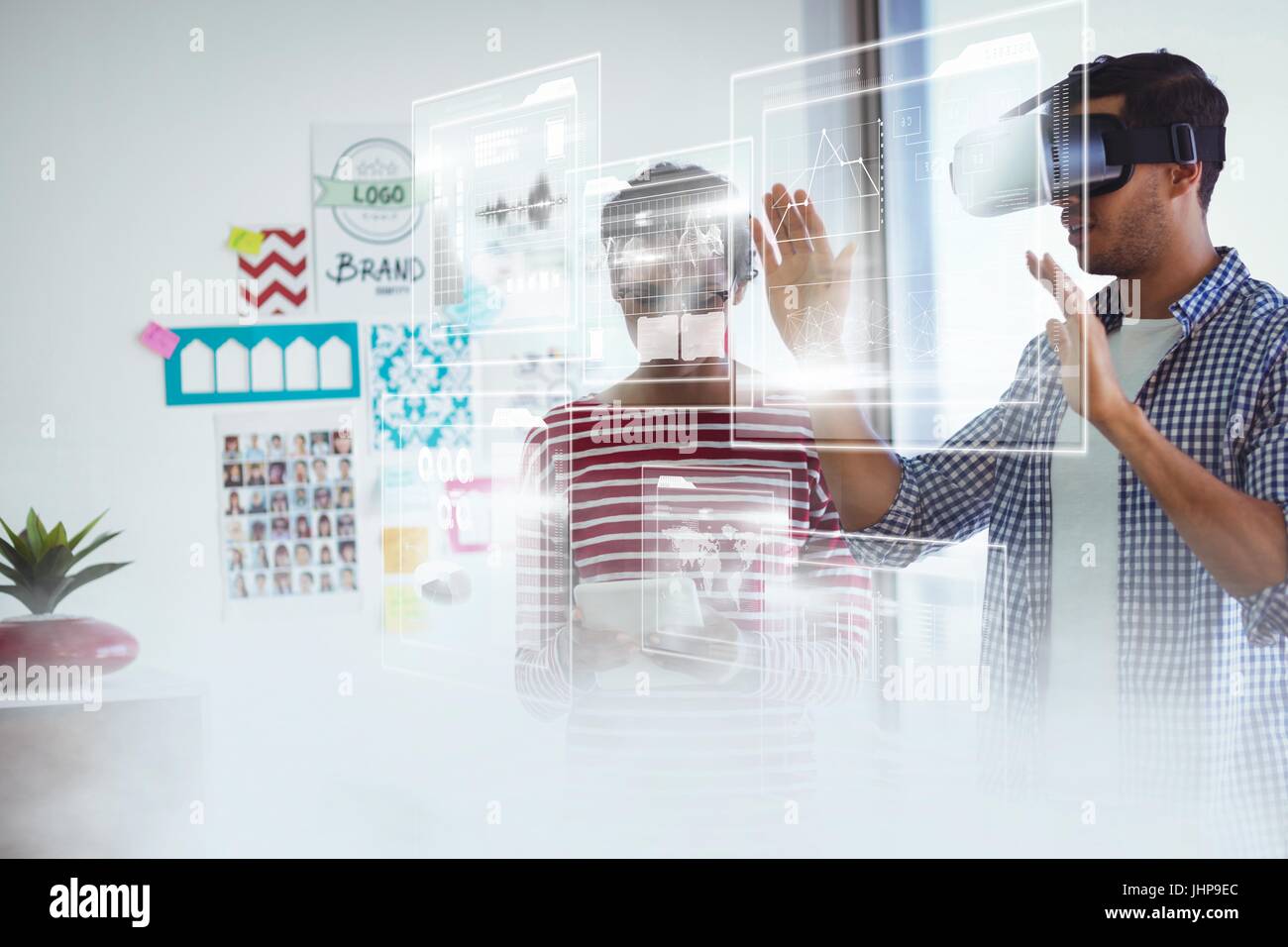 Digital composite of Man in VR headset touching interface Stock Photo ...