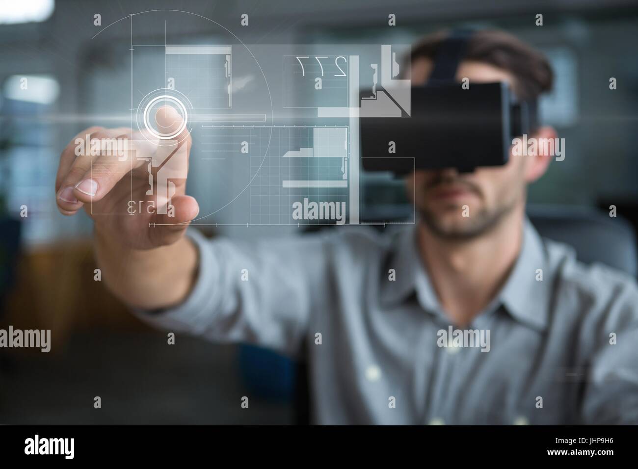 Digital composite of Man in VR headset touching interface with flare ...