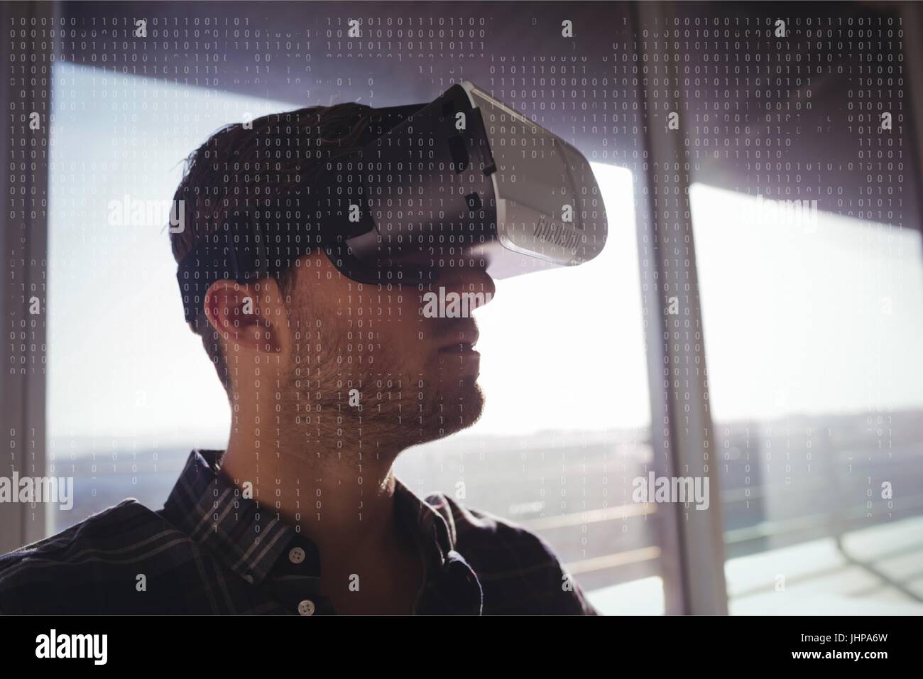 Digital composite of Man in VR headset standing behind interfaces Stock ...