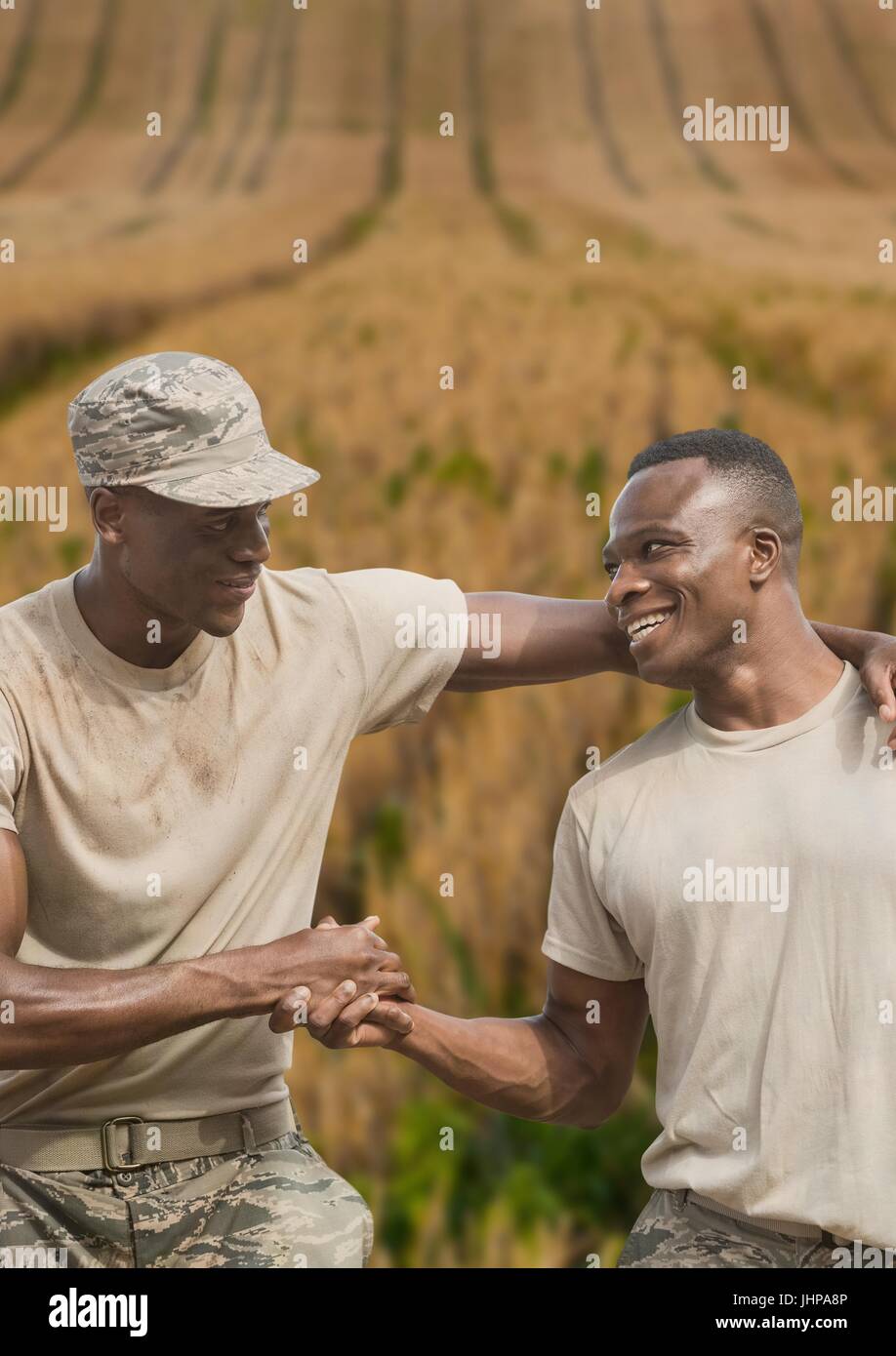 Digital composite of Happy soldier men giving hands against field ...
