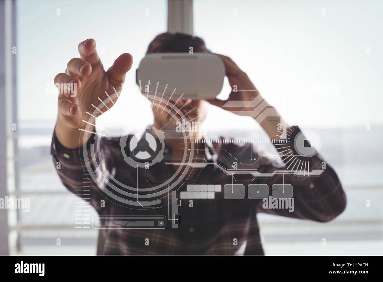 Digital composite of Man in VR headset touching interface Stock Photo ...