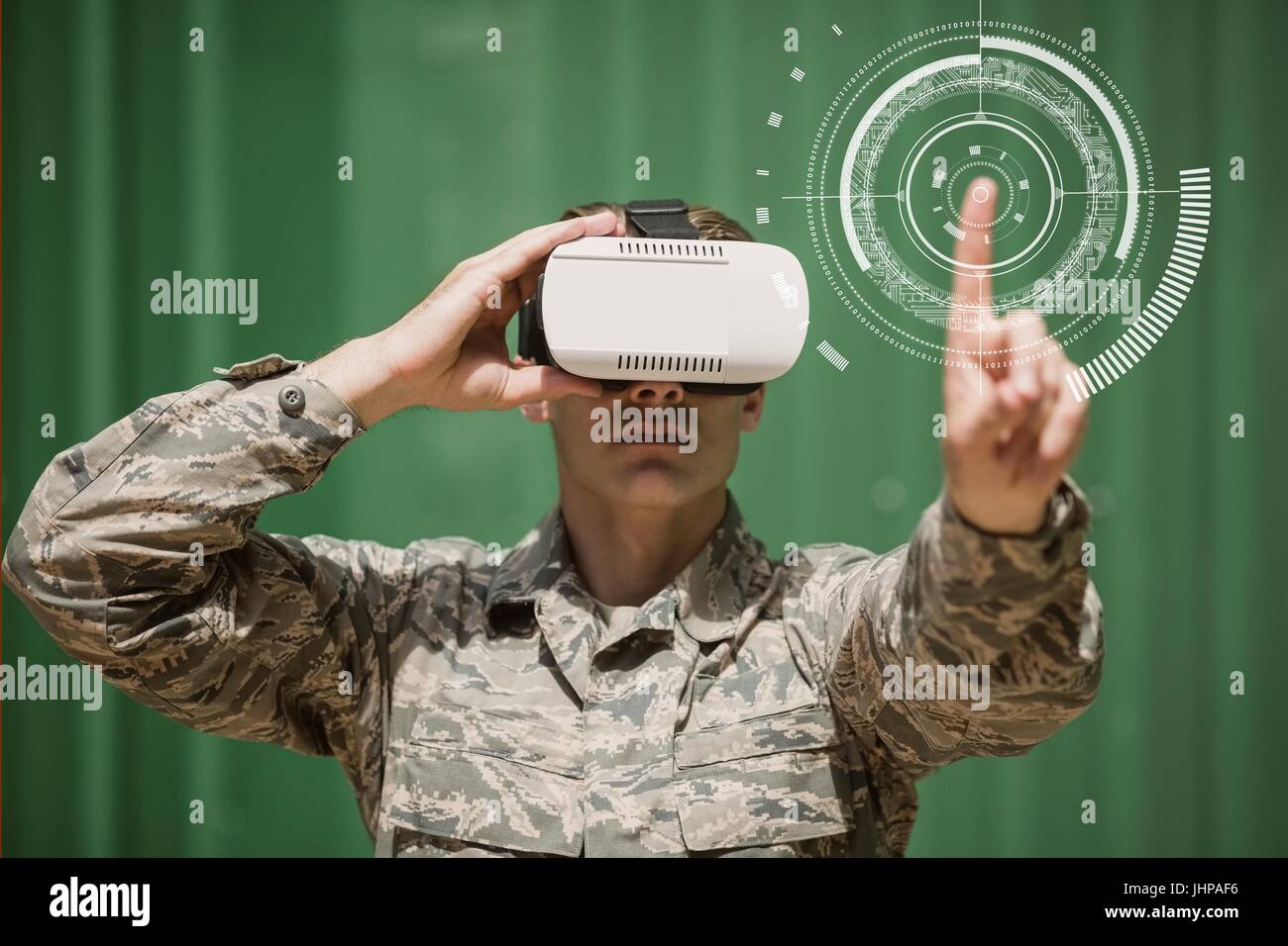 Digital composite of Military man in VR headset touching interface ...