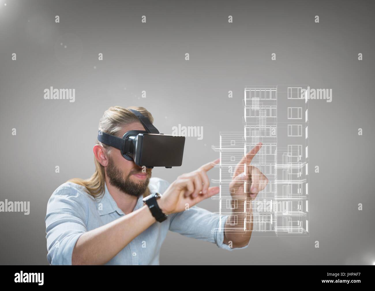 Digital composite of Man in VR headset touching building interface ...