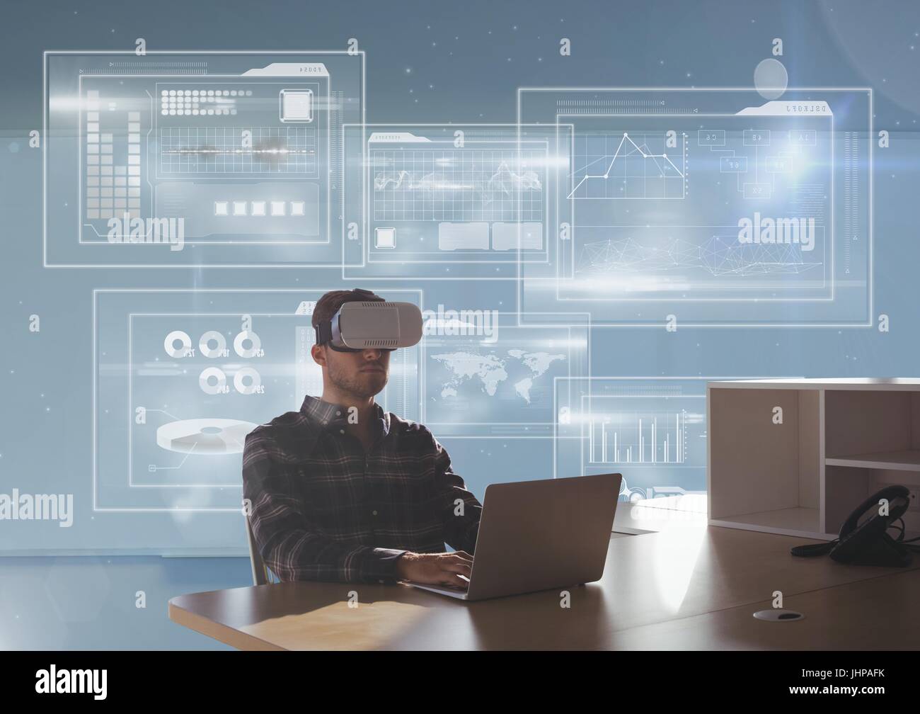 Digital composite of Man in VR headset using the computer against blue ...