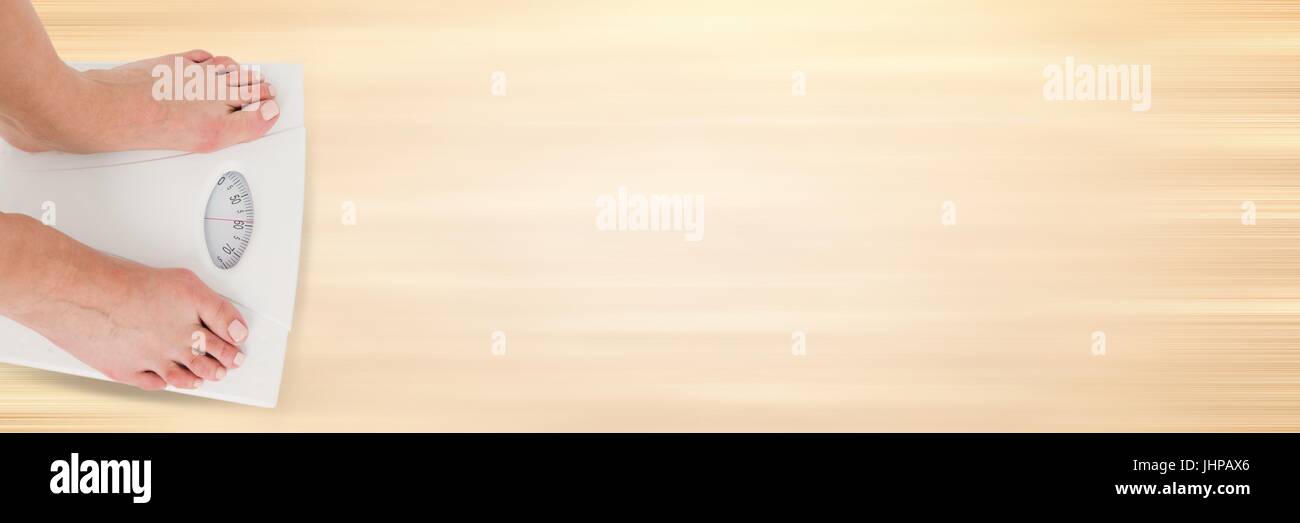 Digital composite of Feet on weighing scales Stock Photo - Alamy