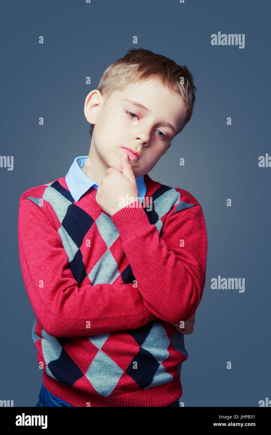 thoughtful sad boy isolated against grey background Stock Photo - Alamy