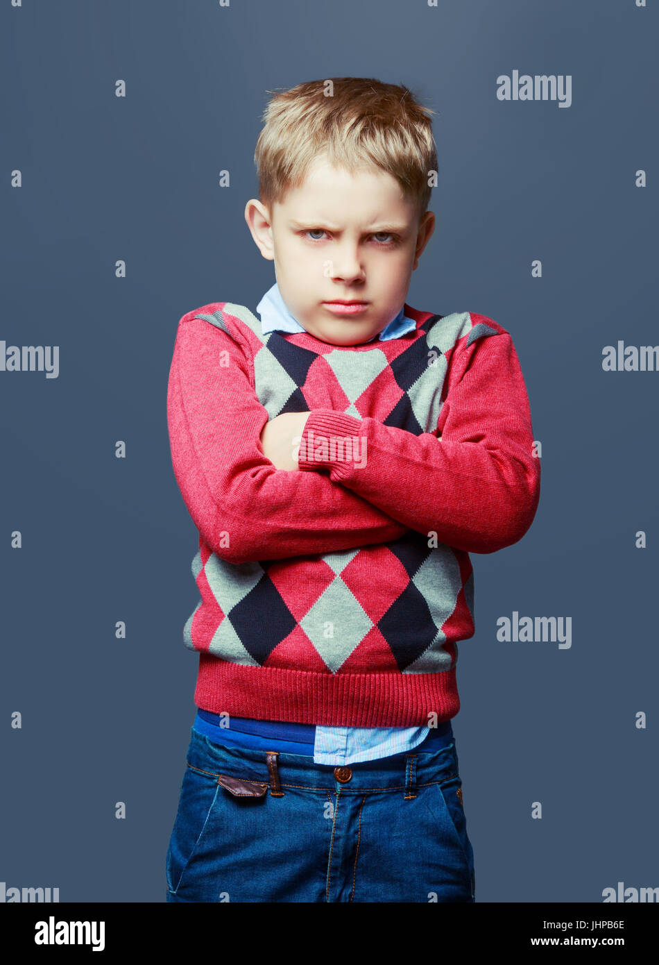 angry boy isolated against grey background Stock Photo - Alamy