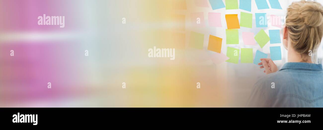 Digital composite of Back of woman looking at sticky notes and blurry ...