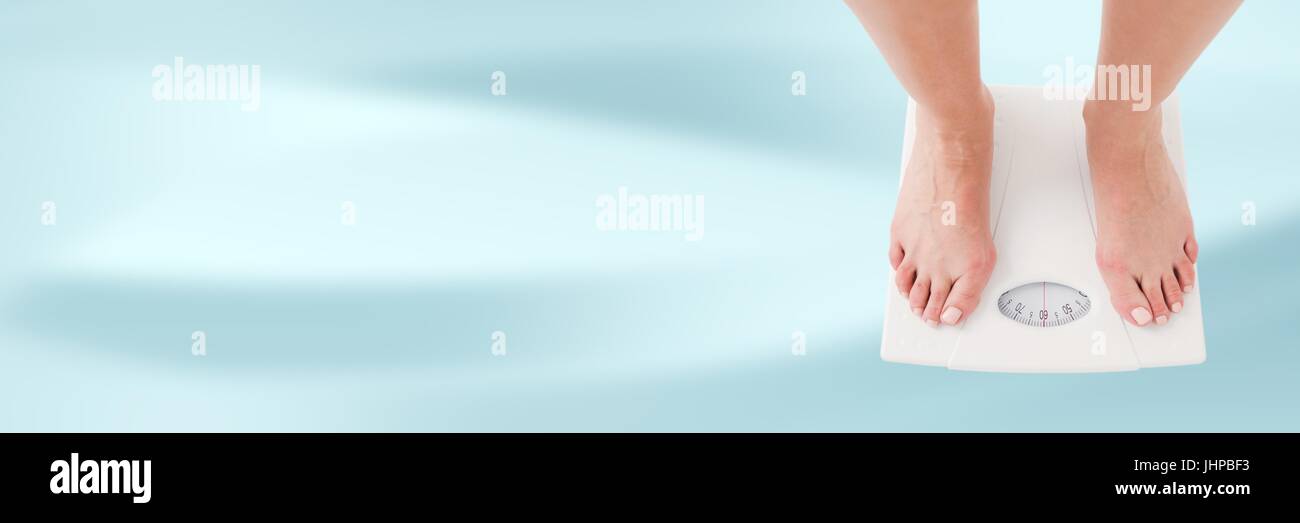 Digital composite of Feet on weighing scales Stock Photo - Alamy