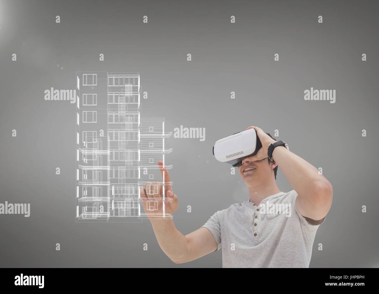 Digital composite of Man in VR headset touching building interface ...