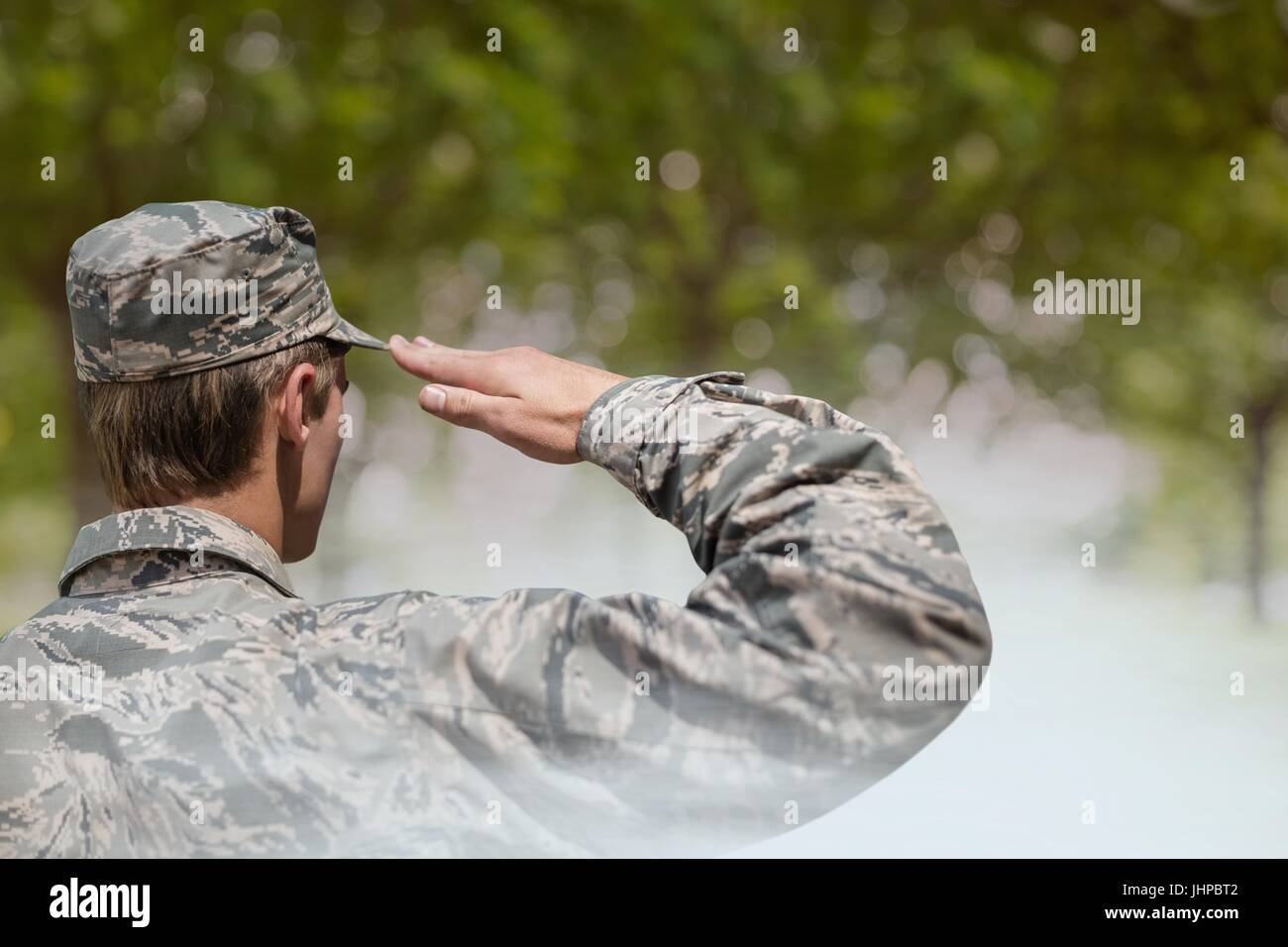 Digital composite of Soldier man raising arm against green background ...