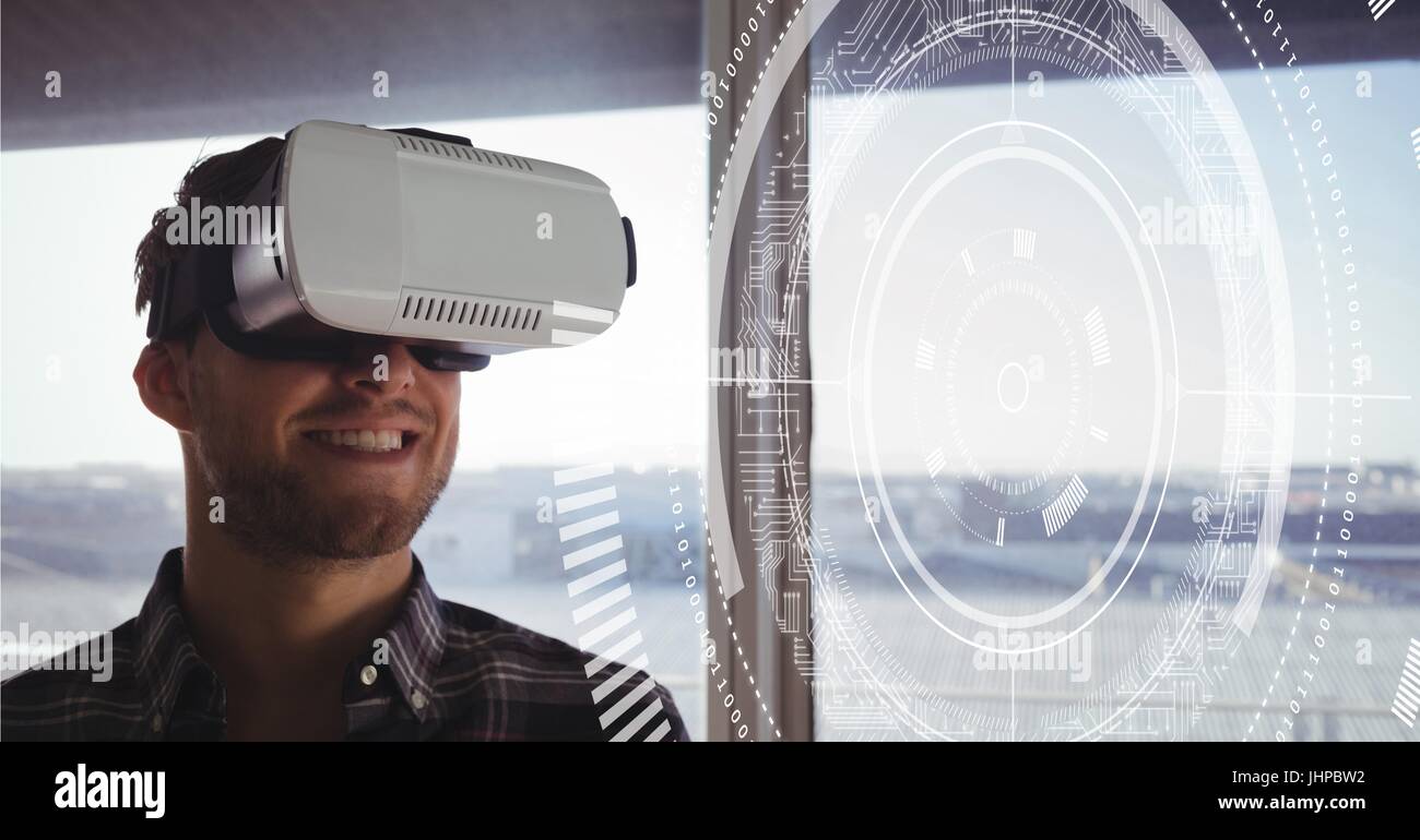 Digital composite of Happy man in VR headset looking at interface Stock ...