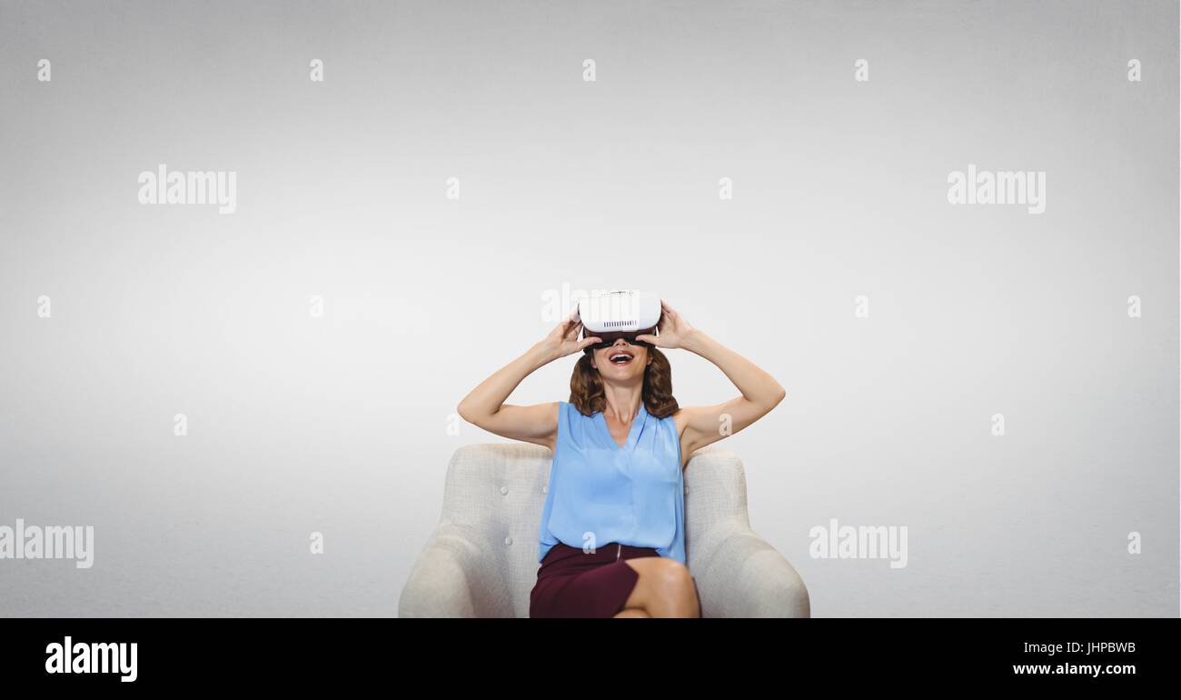 Digital composite of Woman in VR headset looking up against white ...