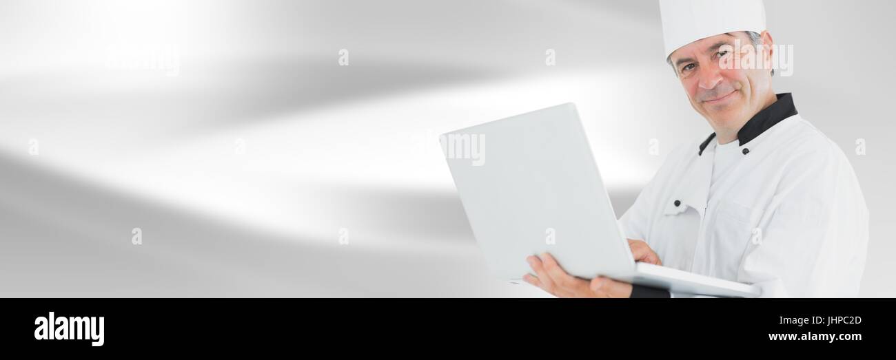 Digital composite of Chef on laptop with blurred background Stock Photo ...