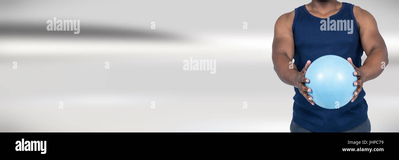 Digital composite of Strong healthy man holding exercise ball Stock ...