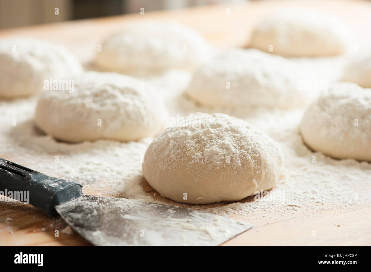 balls of dough covered with wheat flour ready for baking Stock Photo ...