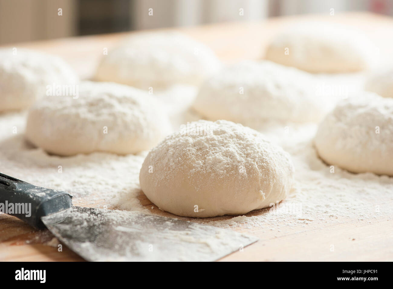 balls of dough covered with wheat flour ready for baking Stock Photo ...