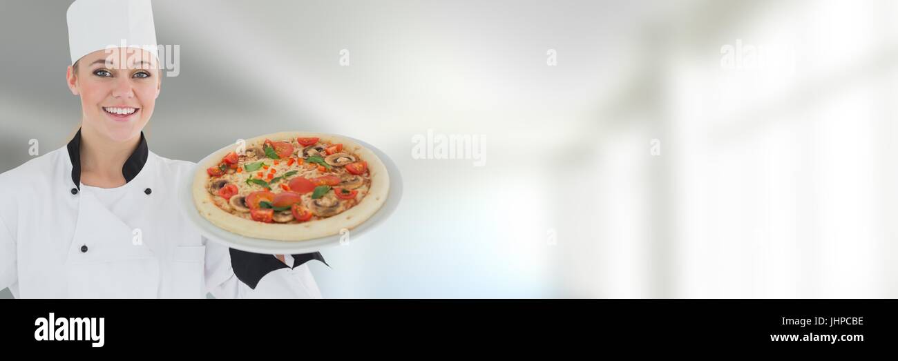 Digital composite of Chef holding pizza with blurred background Stock ...