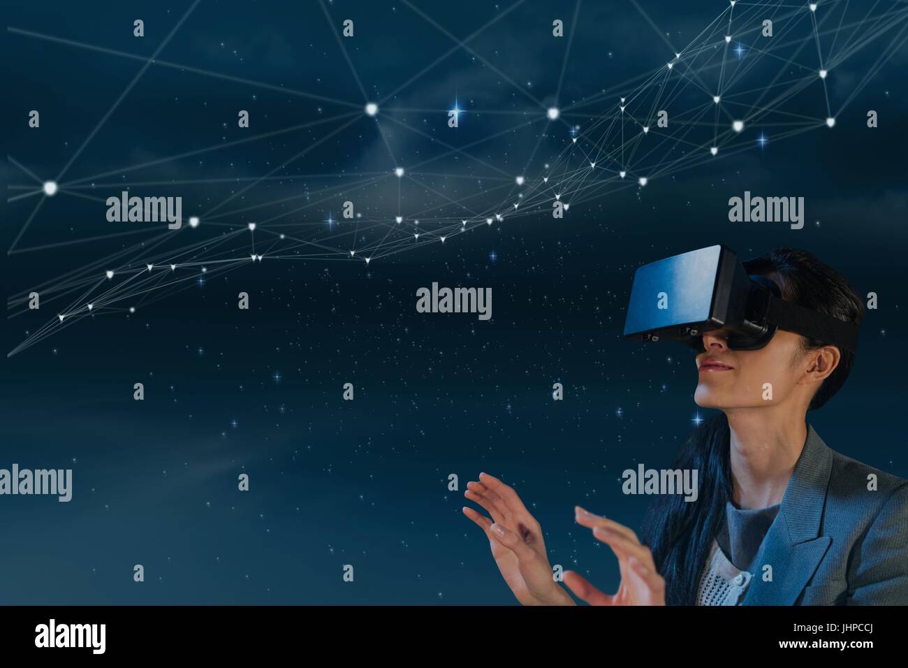 Digital composite of Woman in VR headset looking at stars against blue ...