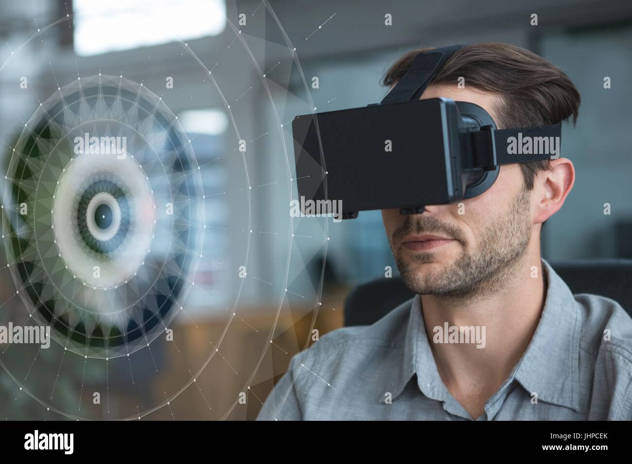Digital composite of Man in VR headset looking at interface Stock Photo ...