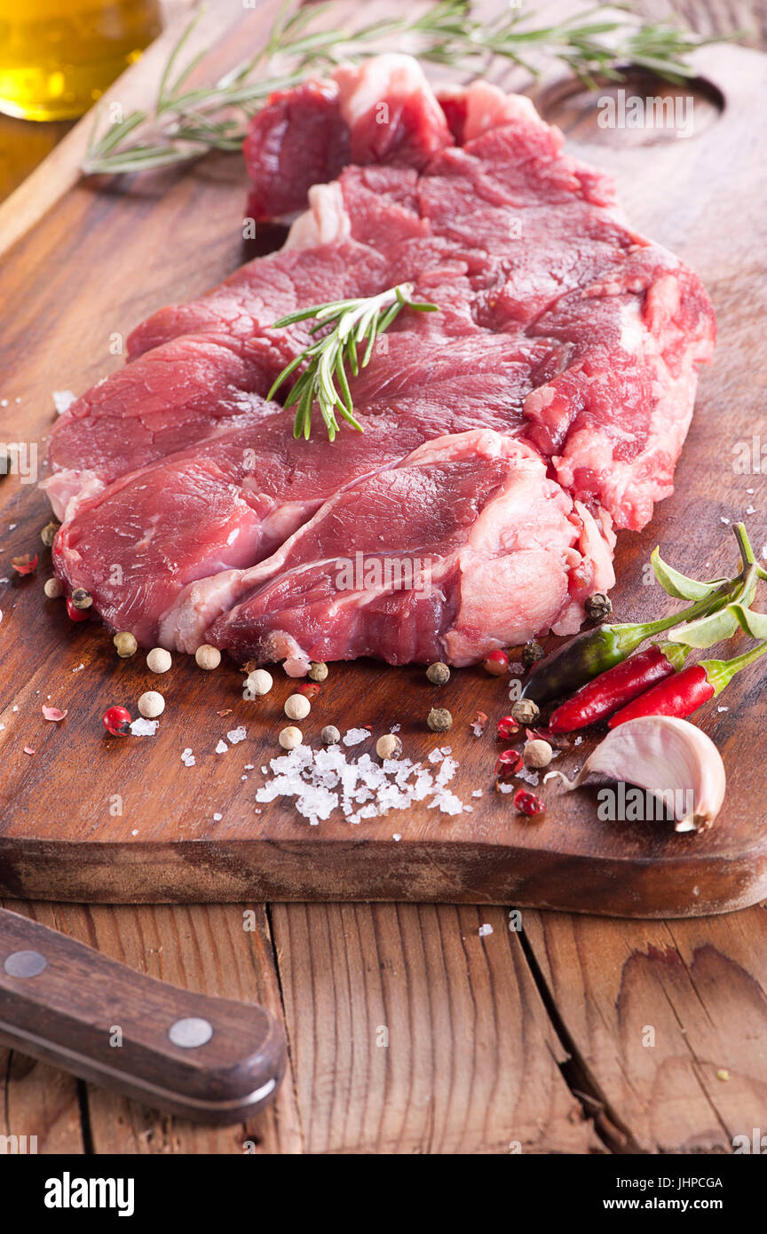 - Raw sliced meat rosemary on wood background Stock Photo - Alamy
