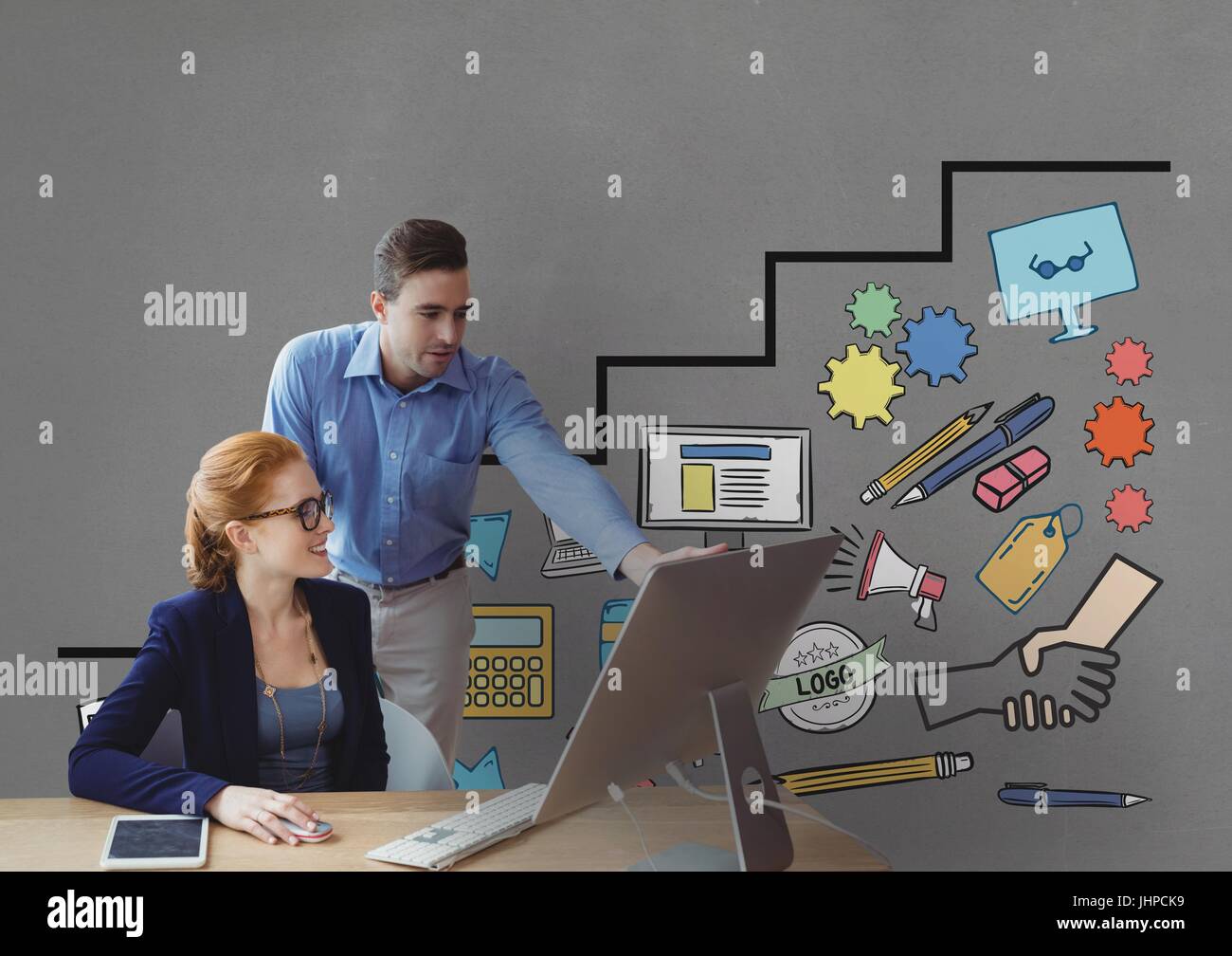 Digital composite of Business people at a desk looking at a computer ...