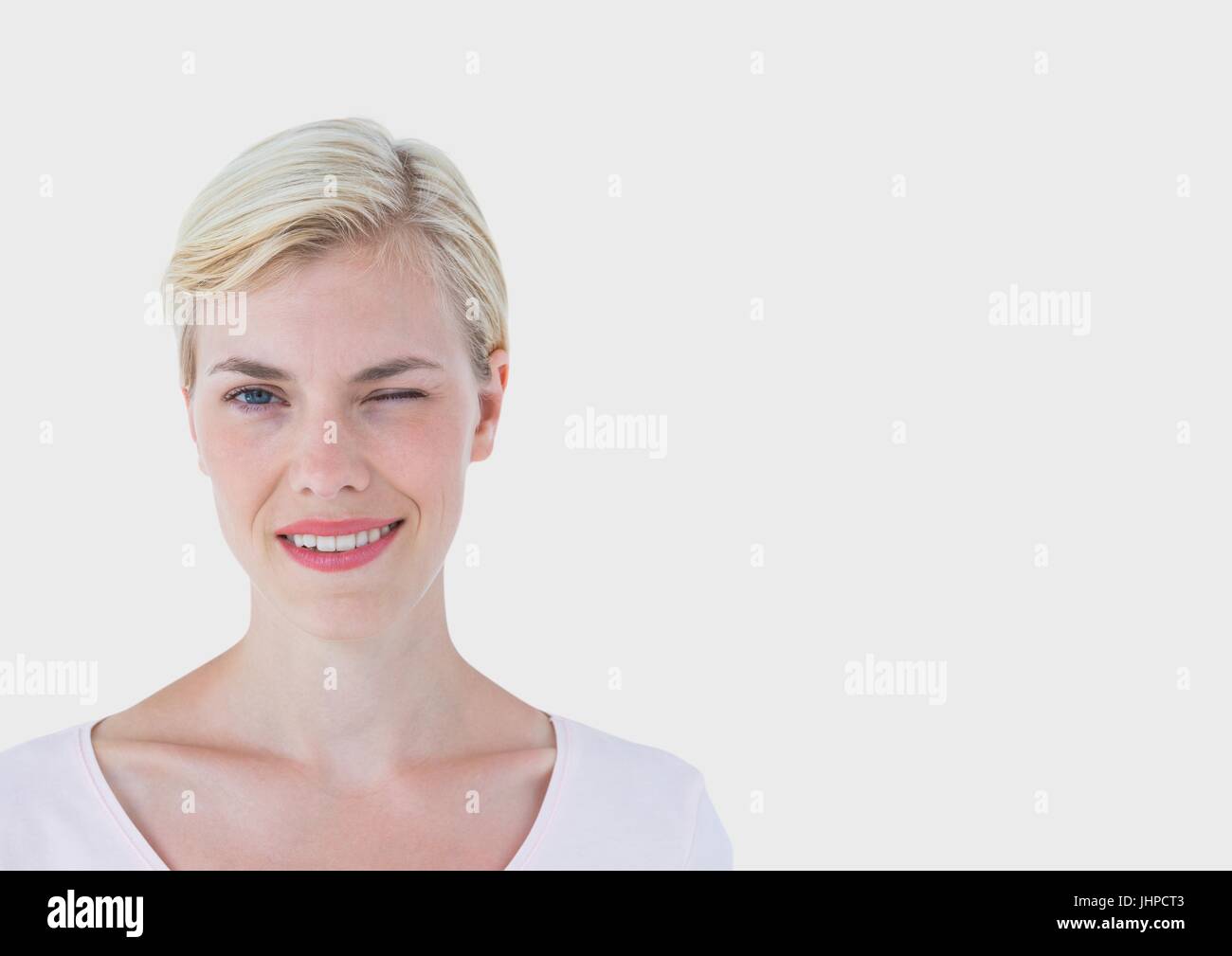 Digital composite of Portrait of woman winking with grey background ...