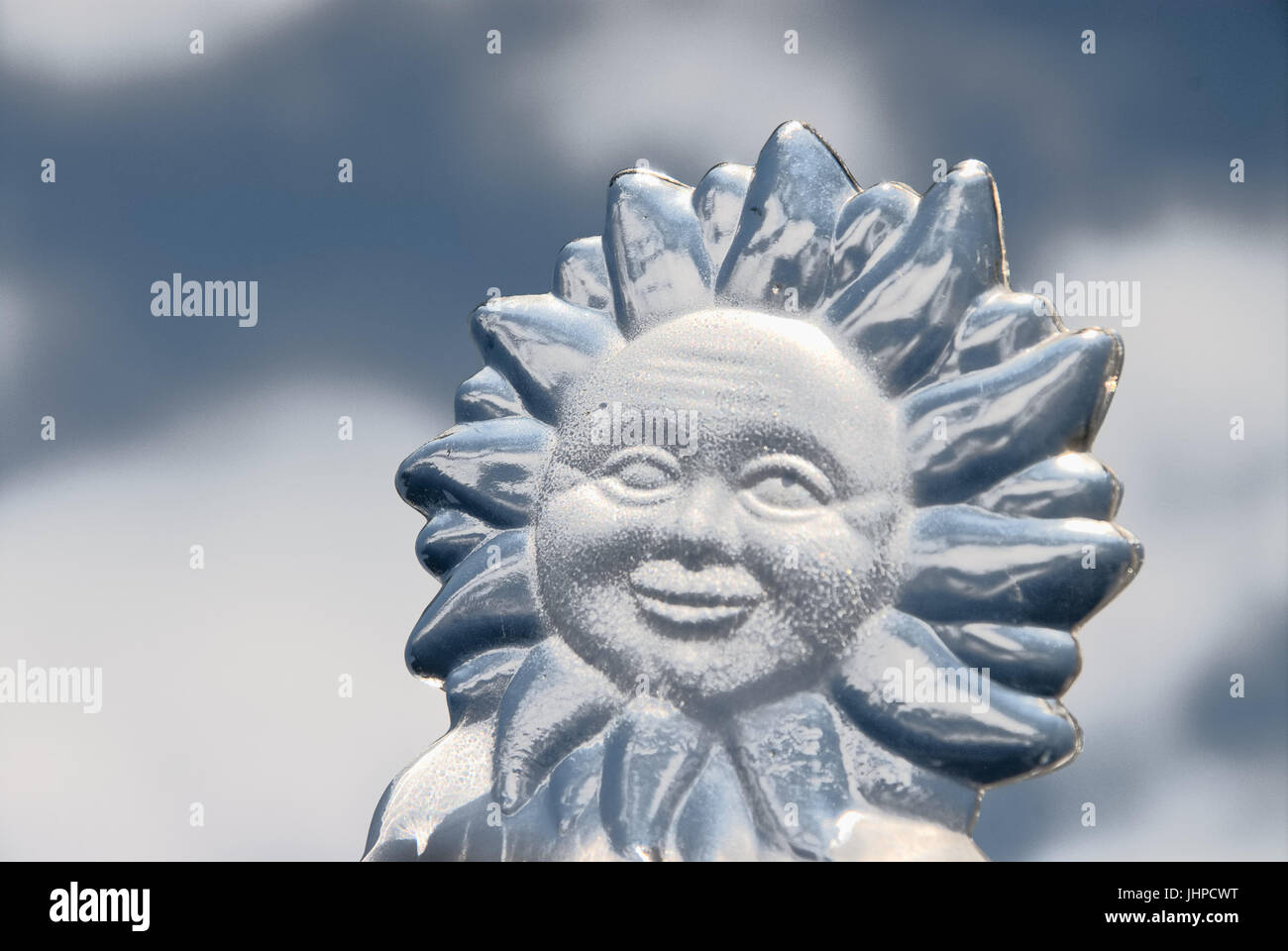 Translucent glass face of sun god sculpture hi-res stock photography ...