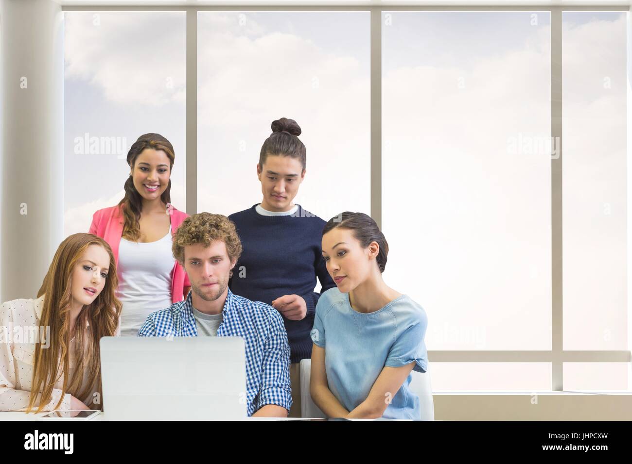 Digital composite of Business people at a desk looking at a computer ...