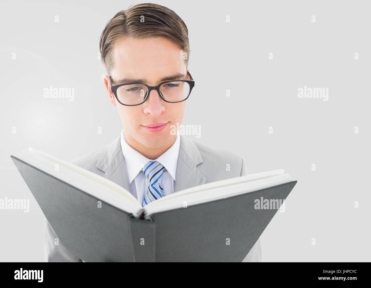 Digital composite of Portrait of Man reading book with grey background ...