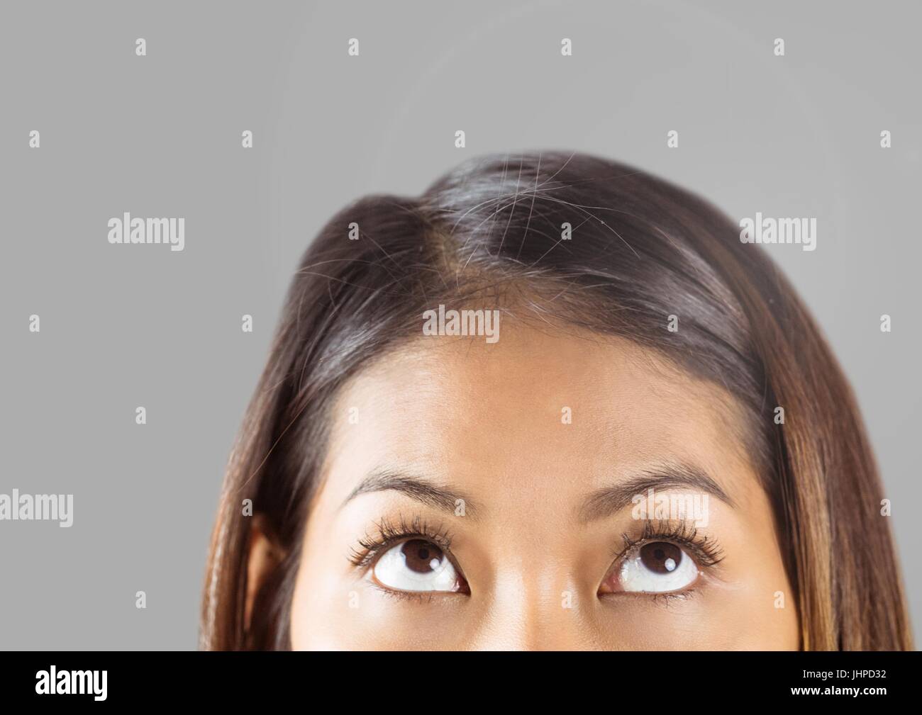 Digital composite of Portrait of woman's eyes with grey background ...