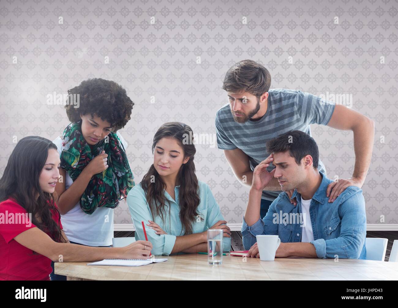 Digital composite of Group of friends sitting in front of blank grey ...