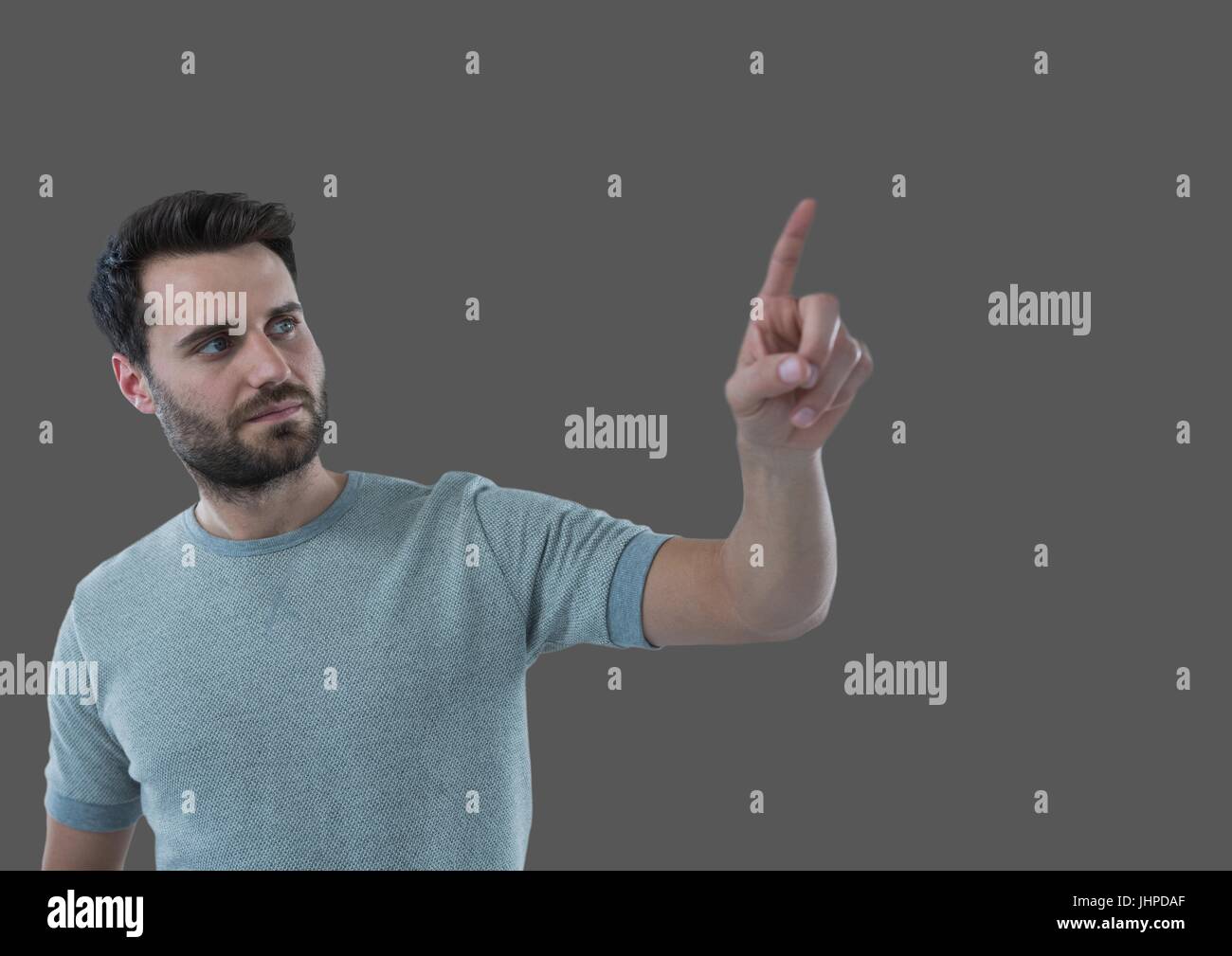 Digital composite of Portrait of Man pointing with grey background ...
