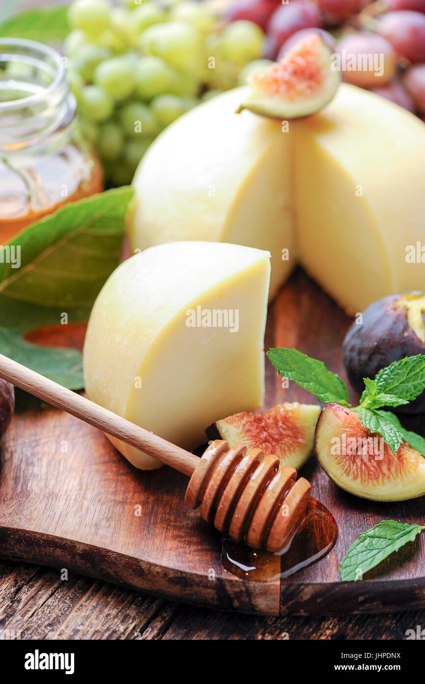 Cheese and ham on wooden table Stock Photo - Alamy