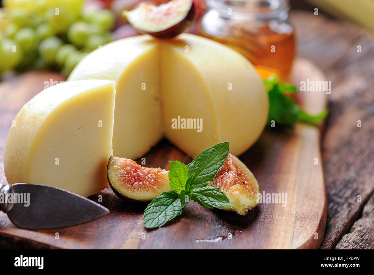 Cheese and ham on wooden table Stock Photo - Alamy