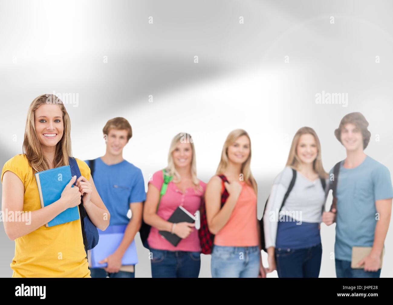 Digital composite of Group of students standing in front of grey ...