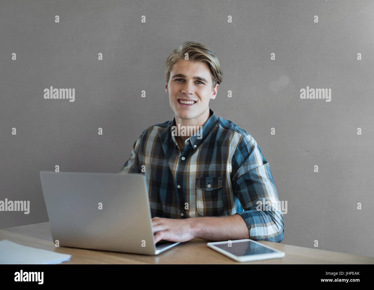 Digital composite of Happy business man at a desk using a computer ...
