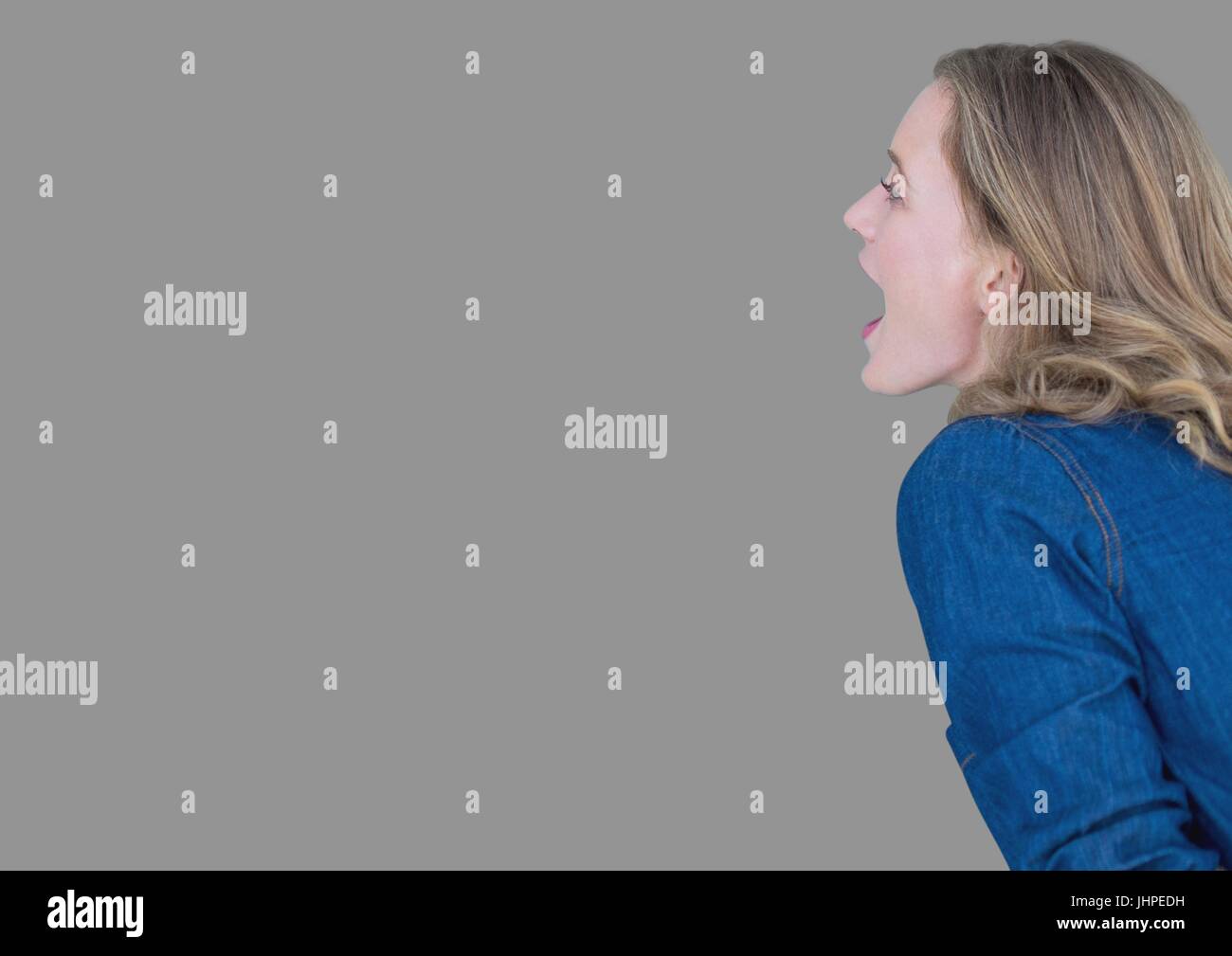 Digital composite of Portrait of woman shouting with grey background ...
