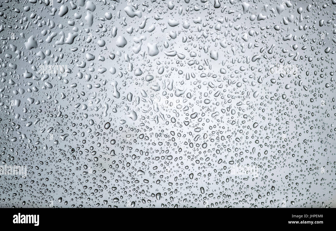 Small Rain water drops and droplets on a clear glass, backlit Stock ...