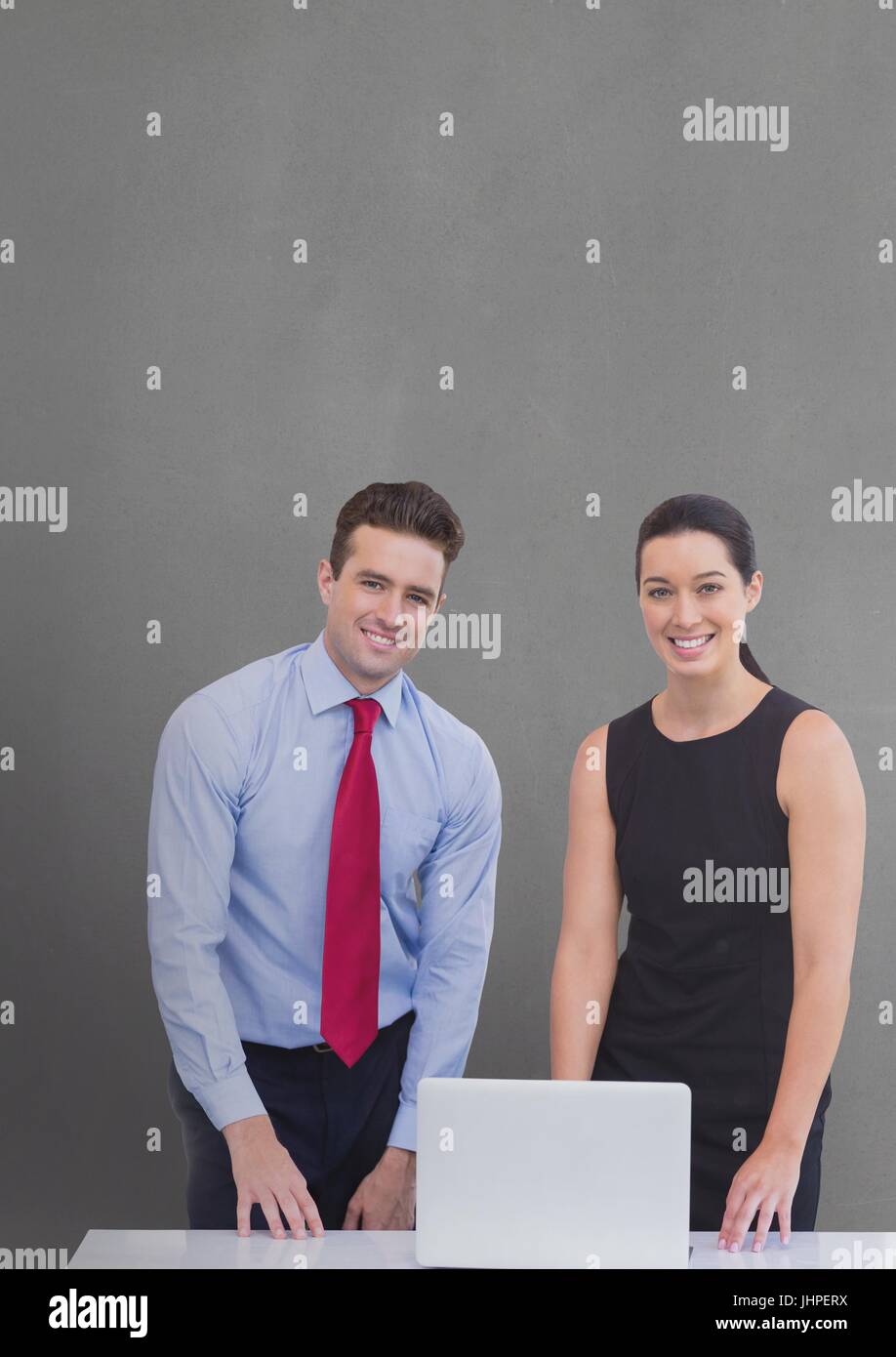Digital composite of Happy business people at a desk using a computer ...