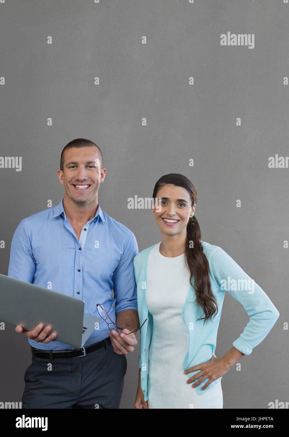 Digital composite of Happy business people holding a computer against ...