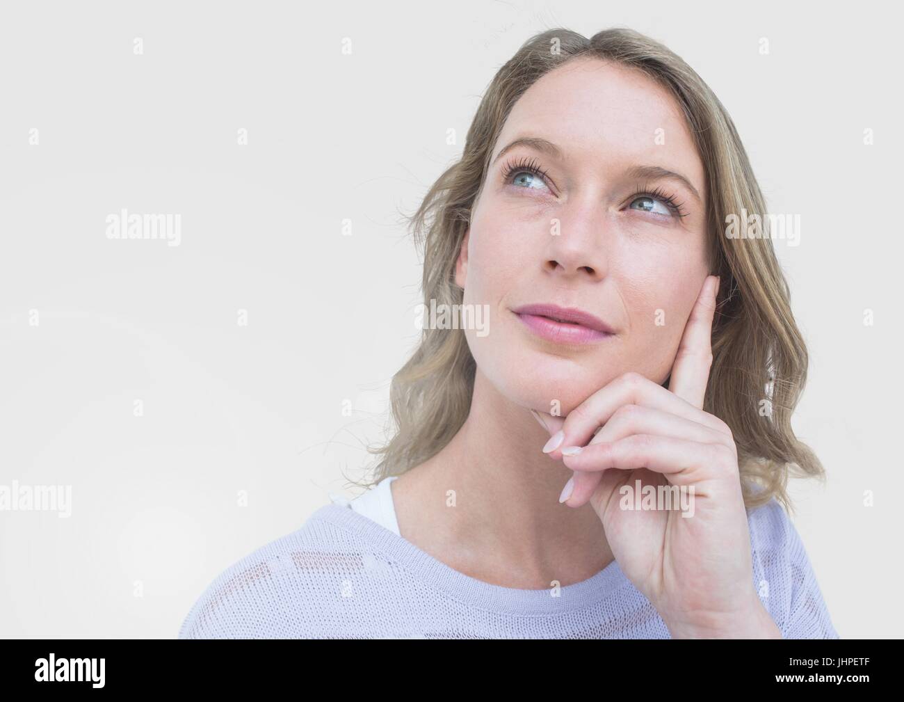 Digital composite of Portrait of woman thinking with grey background ...
