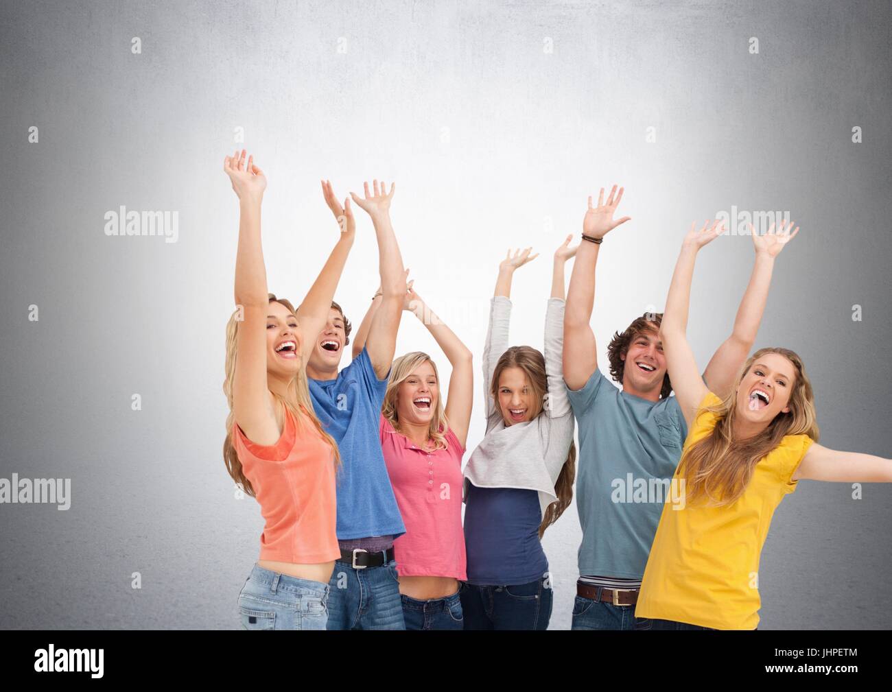 Digital composite of Group of students standing in front of blank grey ...