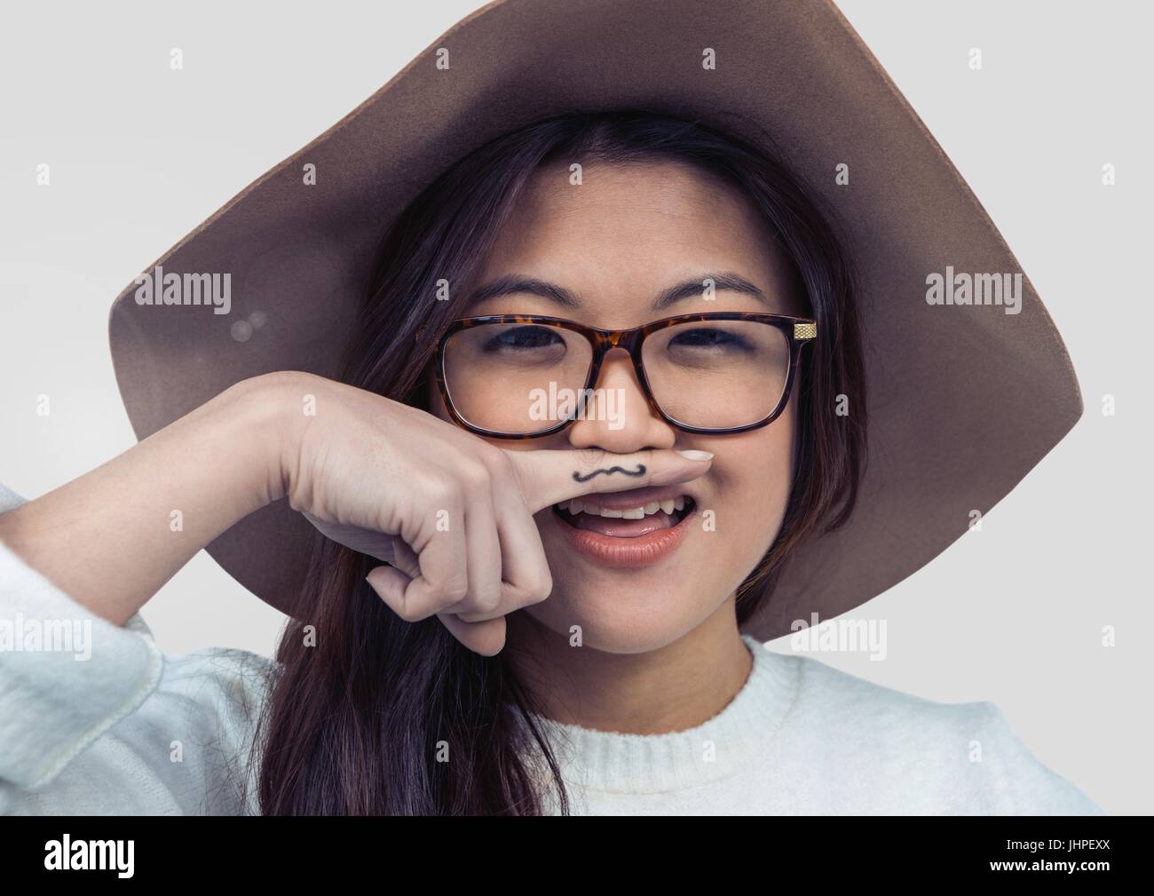 Digital composite of Portrait of woman being silly with grey background ...