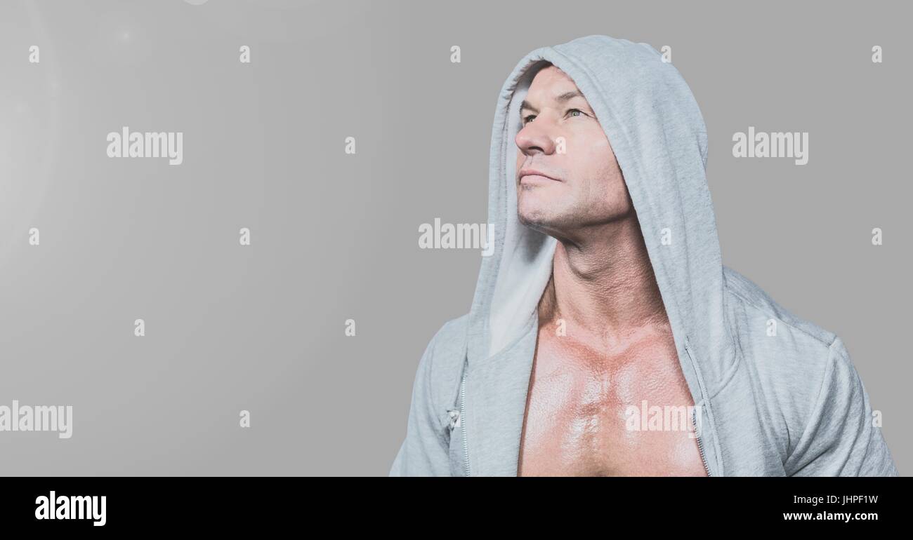 Digital composite of Portrait of muscular strong Man in hoodie with ...