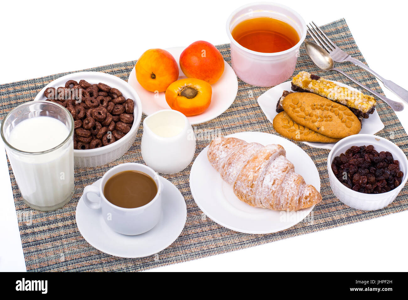 Breakfast table with croissant, muesli, milk, honey and fruits. Studio ...