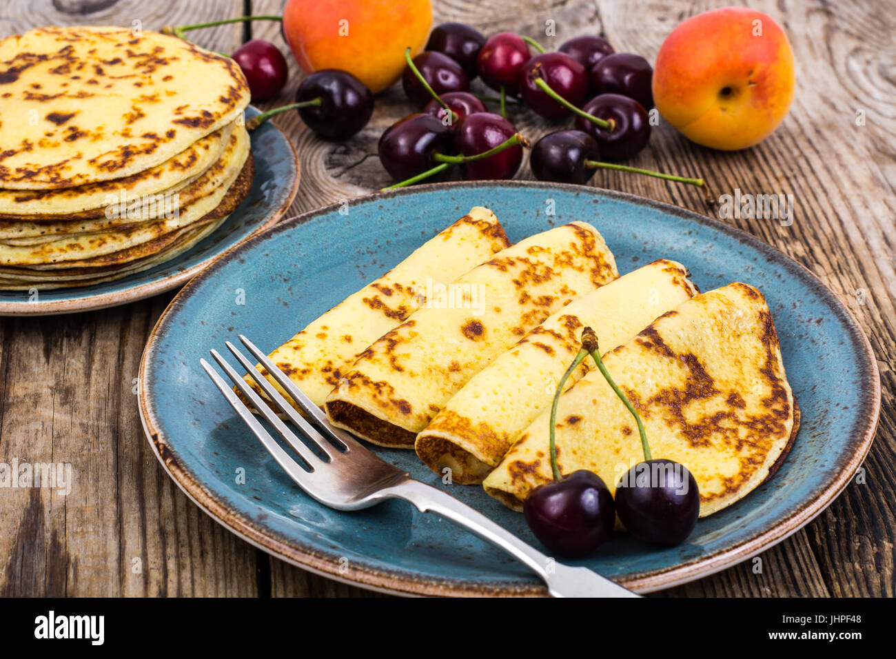 Traditional Russian breakfast pancakes with fruit and honey. Studio ...